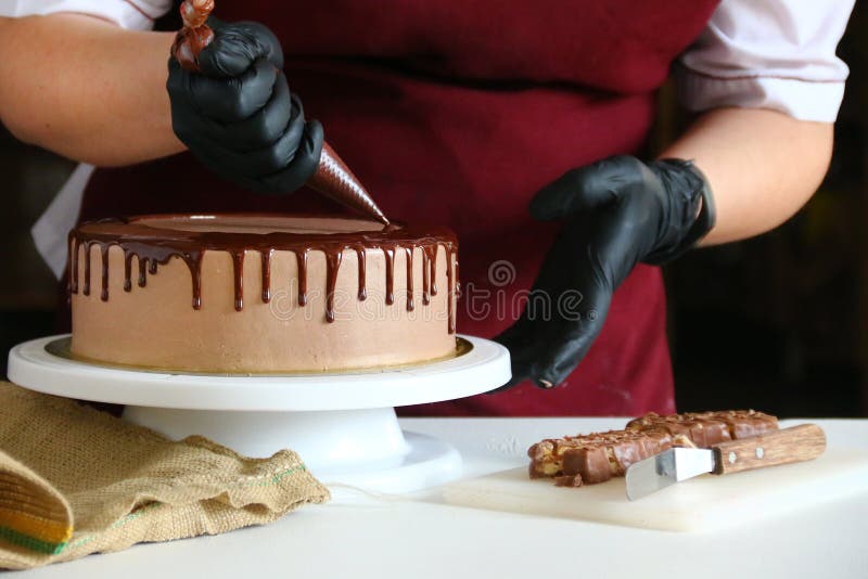 Confectioner Process Chocolate Cake on Table. the Process of Decorating ...