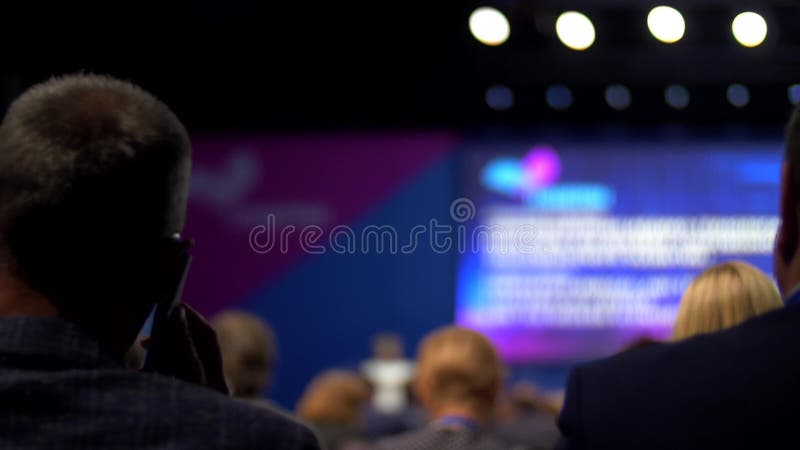 People Listen To the Presentation the Conference Hall. Back View ...