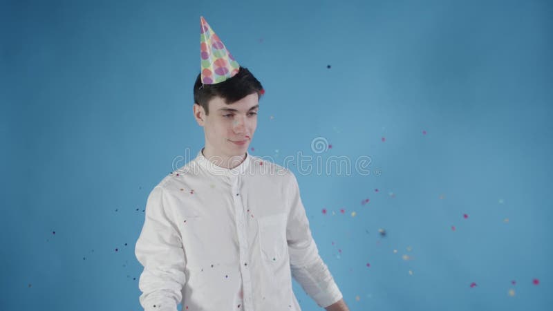 Confetti Was Thrown at the Young Man on a Blue Background. Stock Video ...