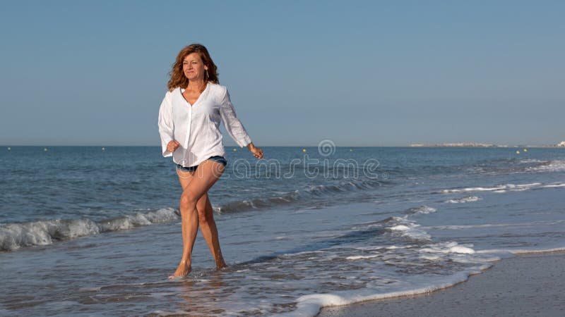 Confidence in Every Step by the Sea, an Optimistic Woman Stock Image ...