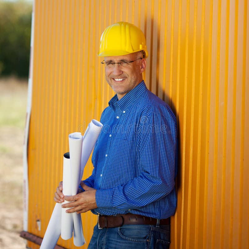 Confident Architect Holding Blueprints while Leaning on Trailer Stock ...
