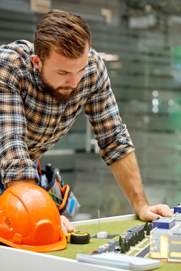 Confident Architect Man Working in Office with Drawings and Building ...
