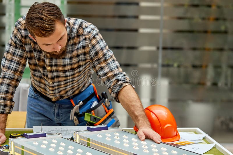 Confident Architect Man Working in Office with Drawings and Building ...