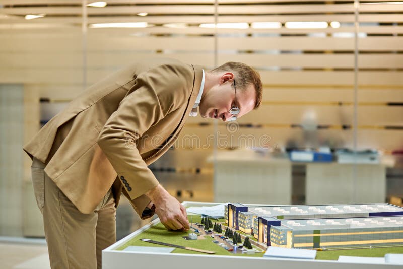 Confident Architect Man Working in Office with Drawings and Building ...