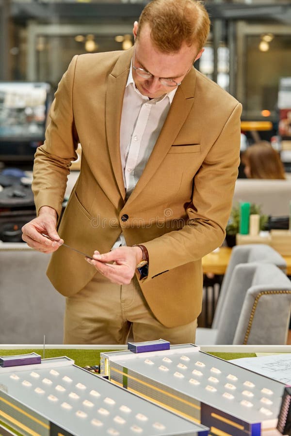 Confident Architect Man Working in Office with Drawings and Building ...