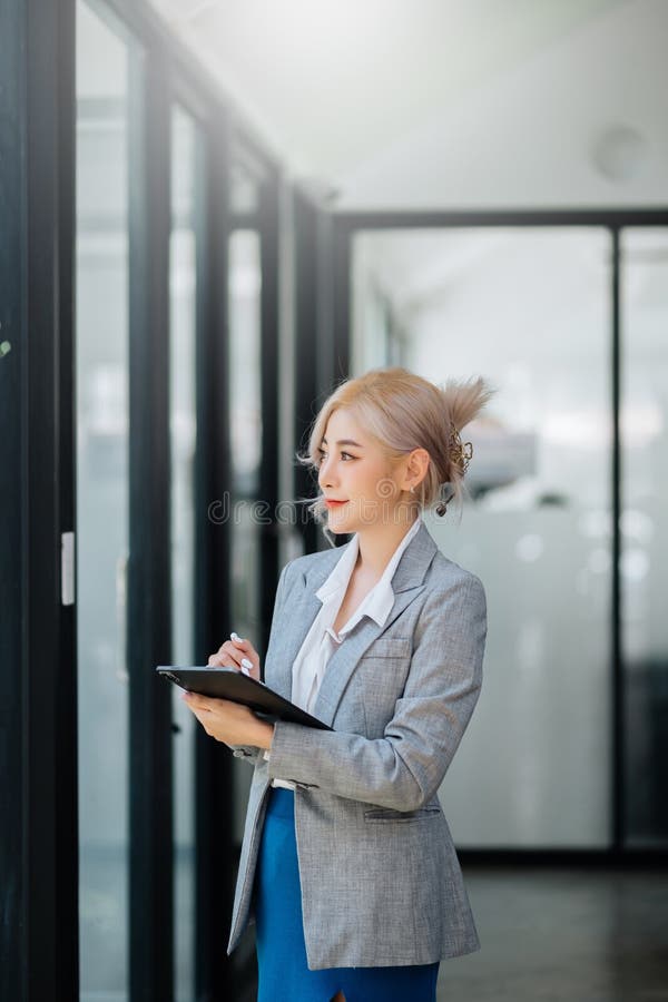 Confident Asian Woman with a Smile Standing Holding Notepad and Tablet ...