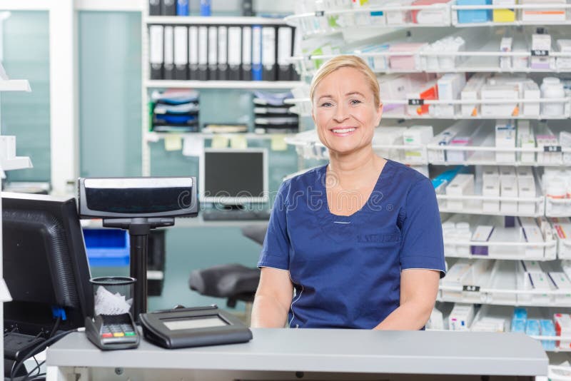 Confident Assistant Sitting at Cash Counter in Stock Photo - Image of ...