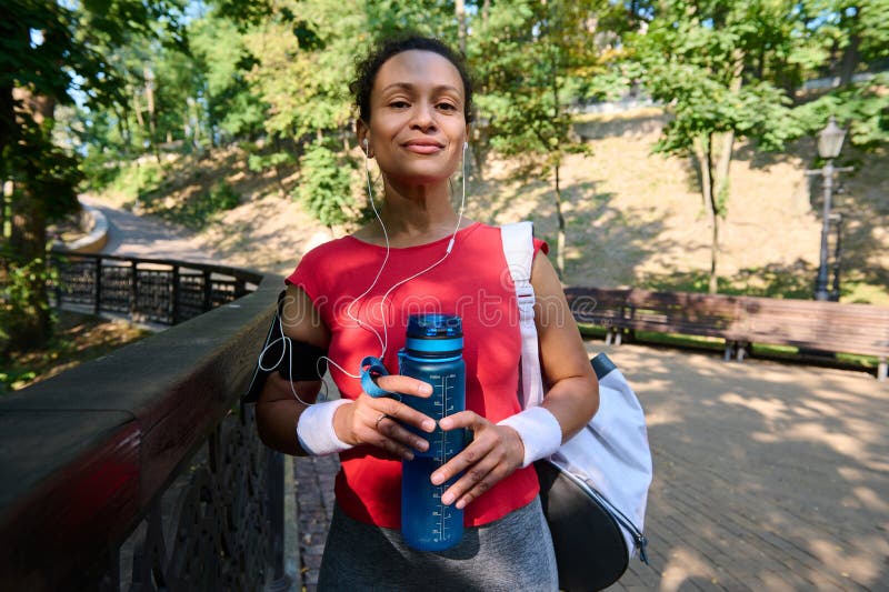 Confident Athletic Woman In Red Tight T Shirt And Terry Wristbands