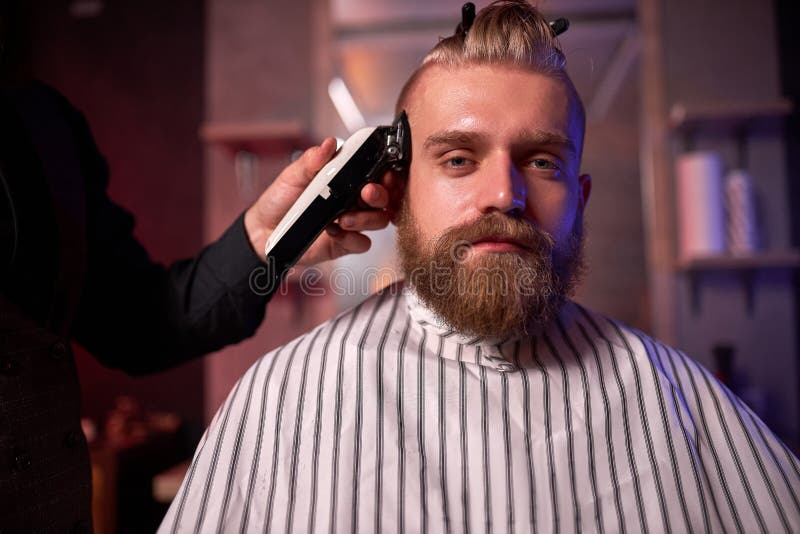 Confident Barber at Barbershop. Barber and Hairdresser Salon. Beard ... Confident Barber at Barbershop. Barber and Hairdresser Salon. Beard ...