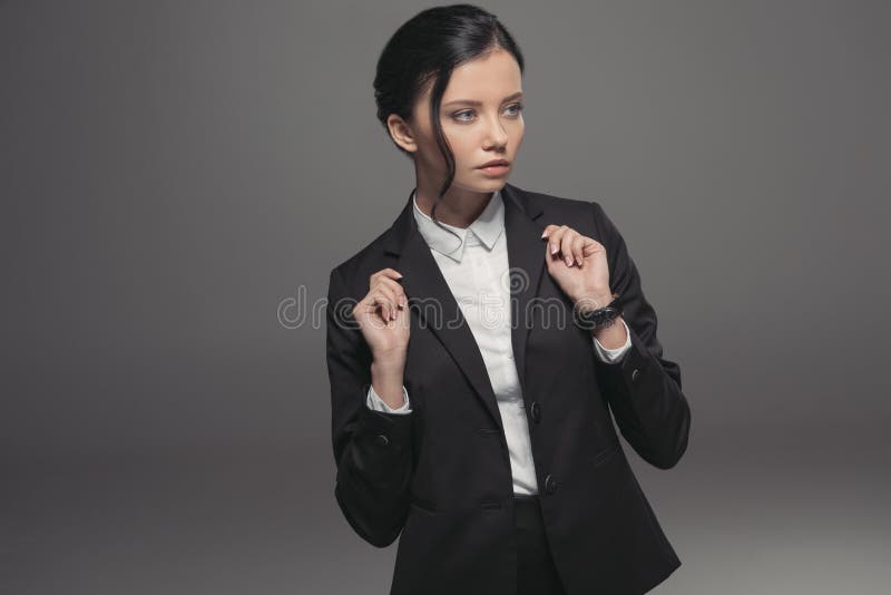 Confident Beautiful Businesswoman Wearing Black Suit And Looking Away