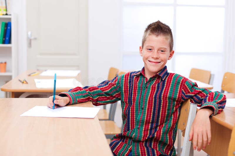 Confident Boy Sitting Alone in Classroom Stock Photo - Image of ...