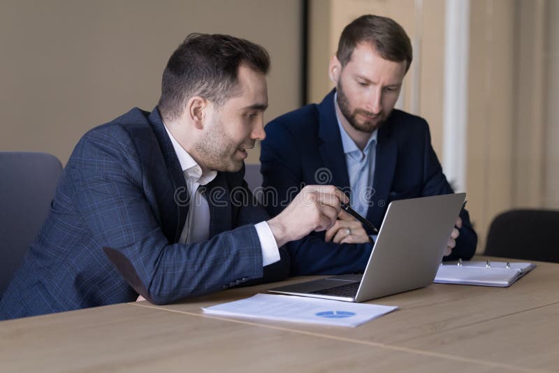 Confident Business Leader Presenting Project Presentation on Laptop ...
