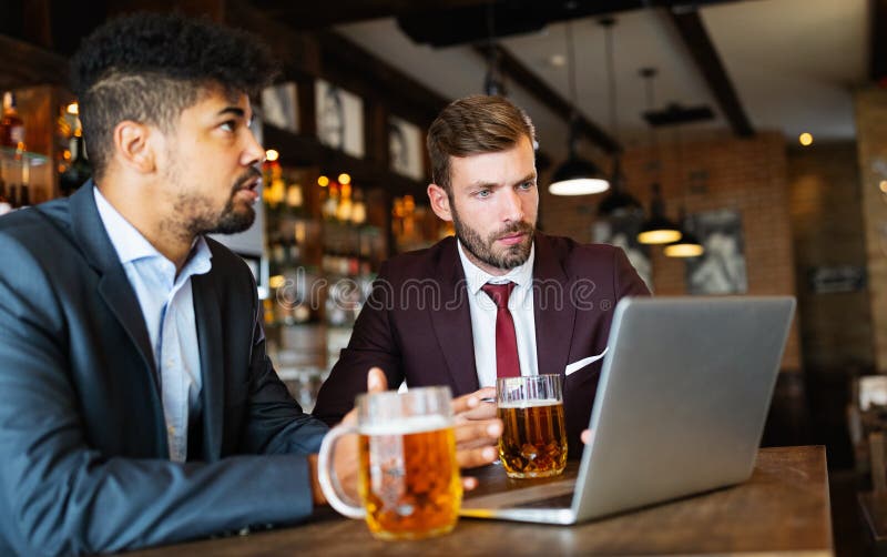 Confident Business Men Talking and Working Together in a Restaurant ...