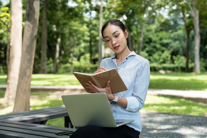 Confident Business Professional Working Outdoors with Laptop and ...