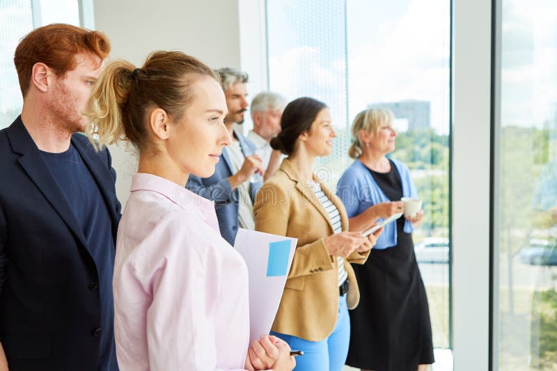 Confident Business Team Looking Out of Window while Standing Together ...