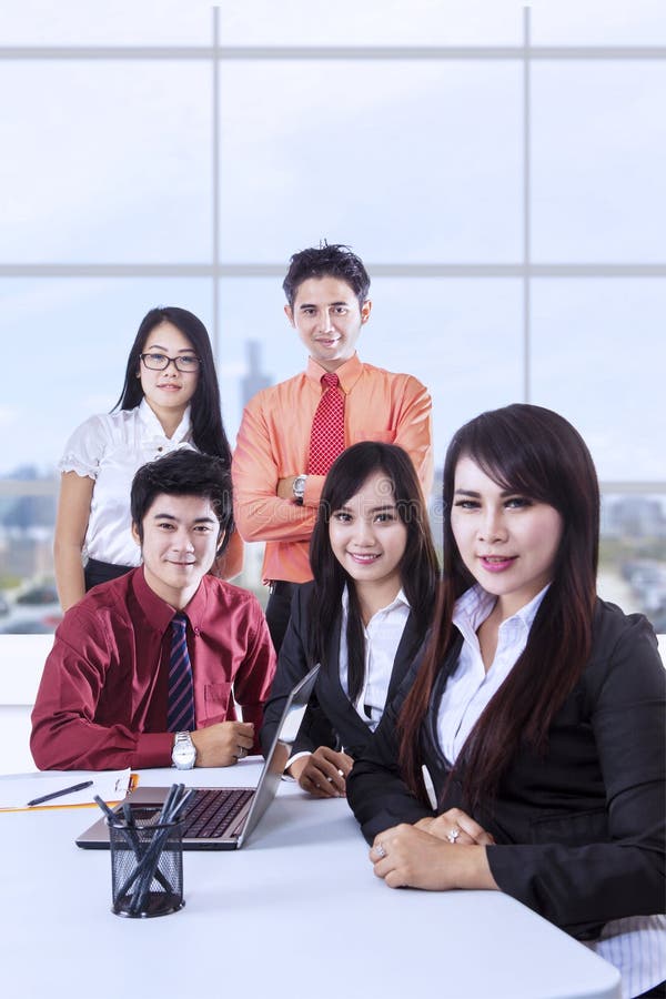 Confident Business Team in Office Stock Photo - Image of laptop, adult ...