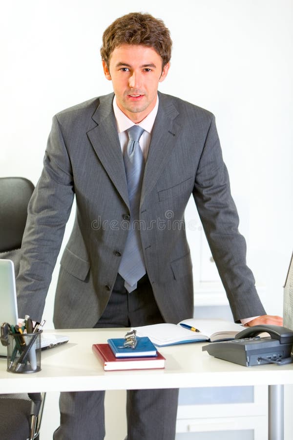 Confident Businessman Holding Hands on Desk Stock Photo - Image of ...
