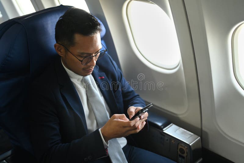 Confident Businessman Passenger Checking News on Smart Phone, Using ...
