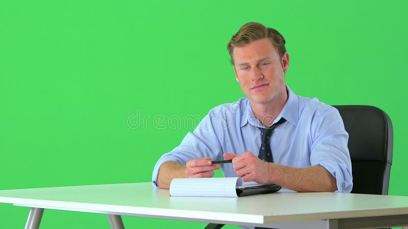 Confident Businessman Sitting at His Desk on Greenscreen Stock Video ...