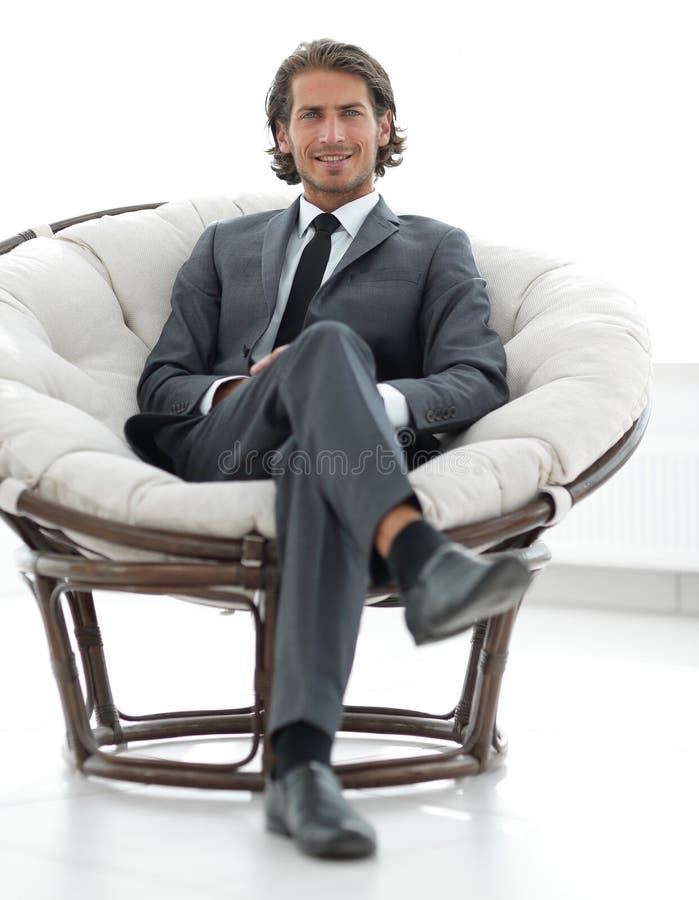 Confident Businessman Sitting in a Large Comfortable Chair. Stock Photo ... Confident Businessman Sitting in a Large Comfortable Chair. Stock Photo ...