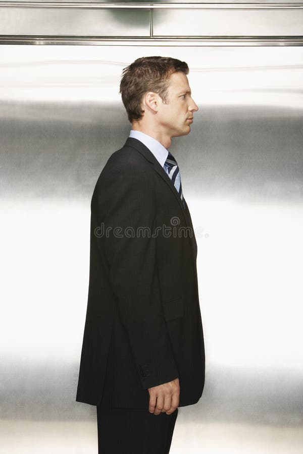 Confident Businessman Standing in Elevator Stock Photo - Image of ...