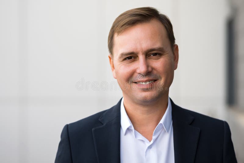 Confident Businessman Stays in Front of Camera and Smiles Stock Photo ...