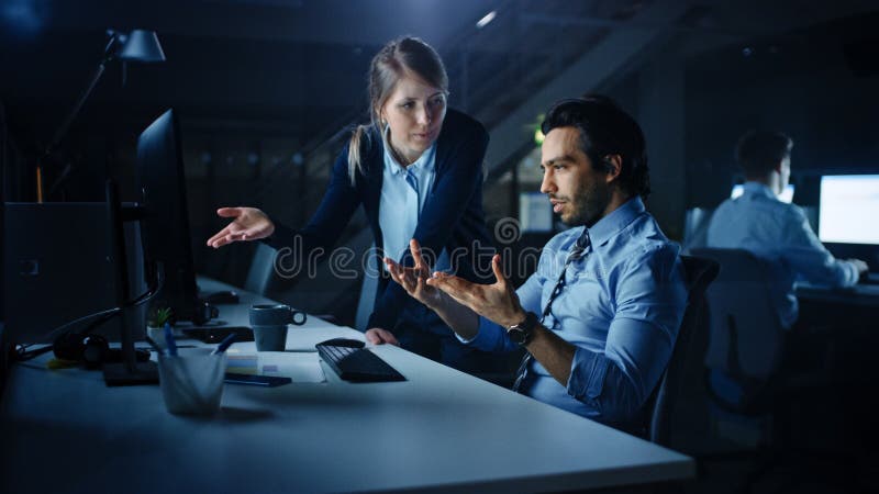 Confident Businessman Uses Desktop Computer, His Female Project Manager ...