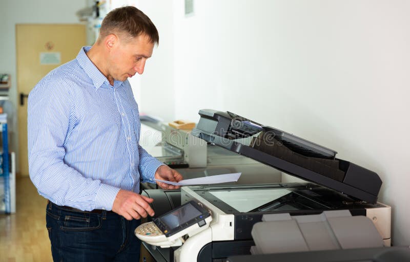 Confident Businessman Using Printer in Office Stock Image - Image of ...