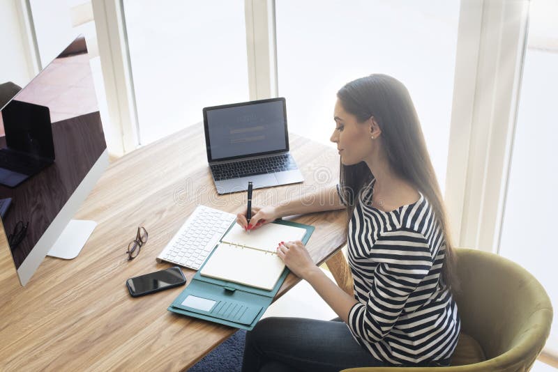 Confident Businesswoman Sitting at Desk while Working from Home Stock ...