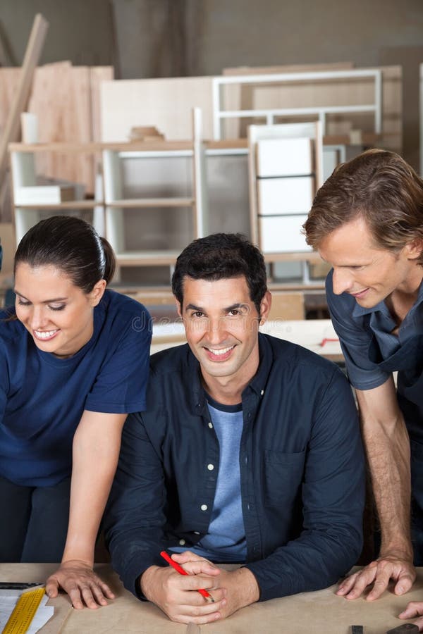 Confident Carpenter with Team at Table Stock Photo - Image of carpentry ...