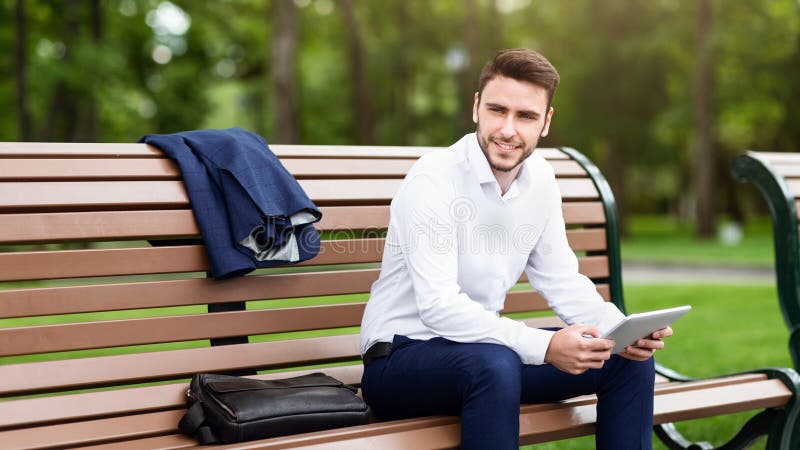 Confident CEO with Tablet Computer Relaxing on Bench in City Park Stock ...