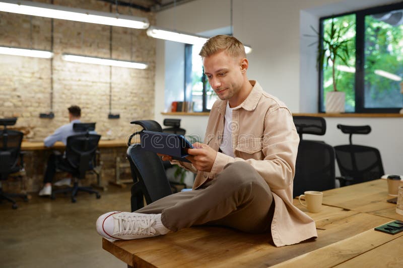 Confident Concentrated Man Creative Worker Sitting on Office Table with ...