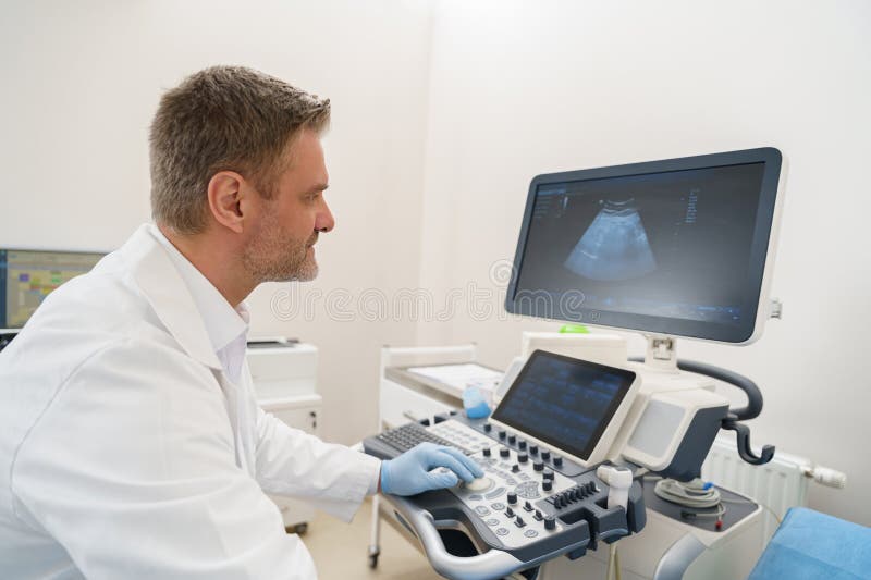 Confident Concentrated Sonographer Looking at the Screen during the ...