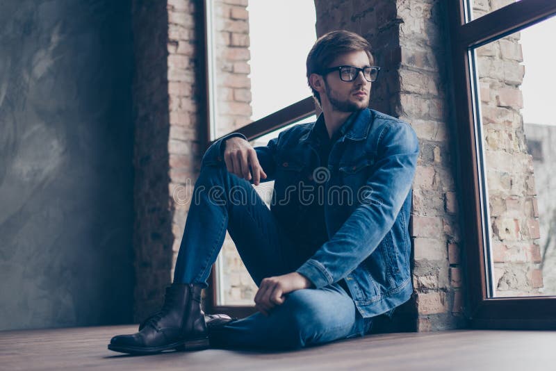 Confident Cute Smart Man with Spectacles in Jeans Sitting on the Floor ...