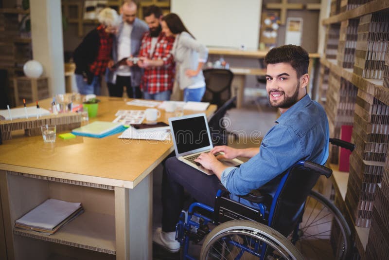 Confident Disabled Businessman Using Laptop at Desk Stock Photo - Image ...