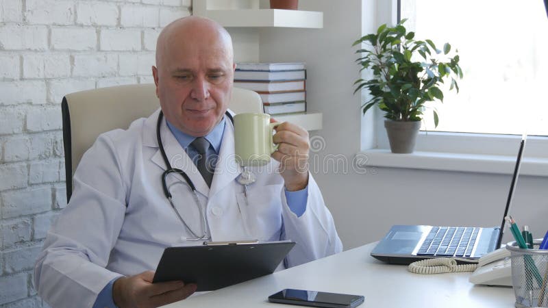 Confident Doctor Enjoy a Cup of Tea and Read Documents Stock Photo ...