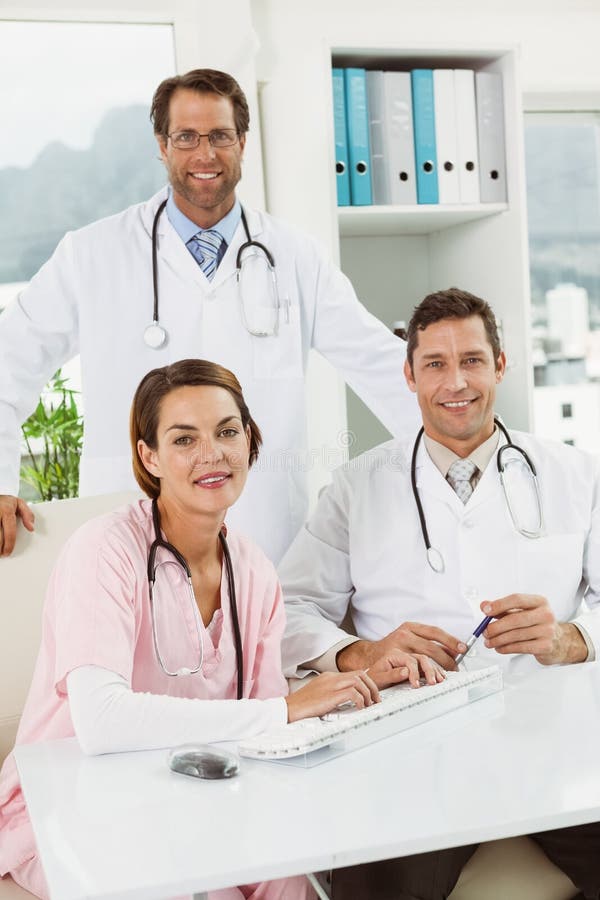 Confident Doctors Smiling at Medical Office Stock Image - Image of ...