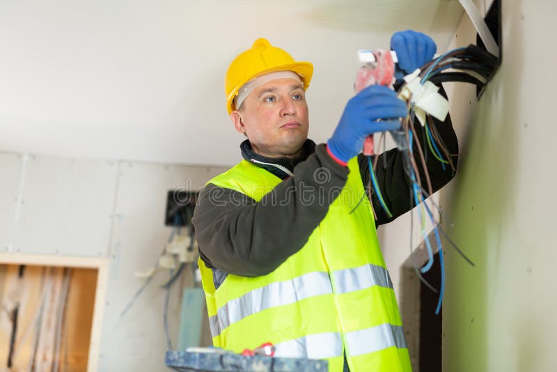 Electrician Mounting Electrical Wiring Inside Building in Process of ...