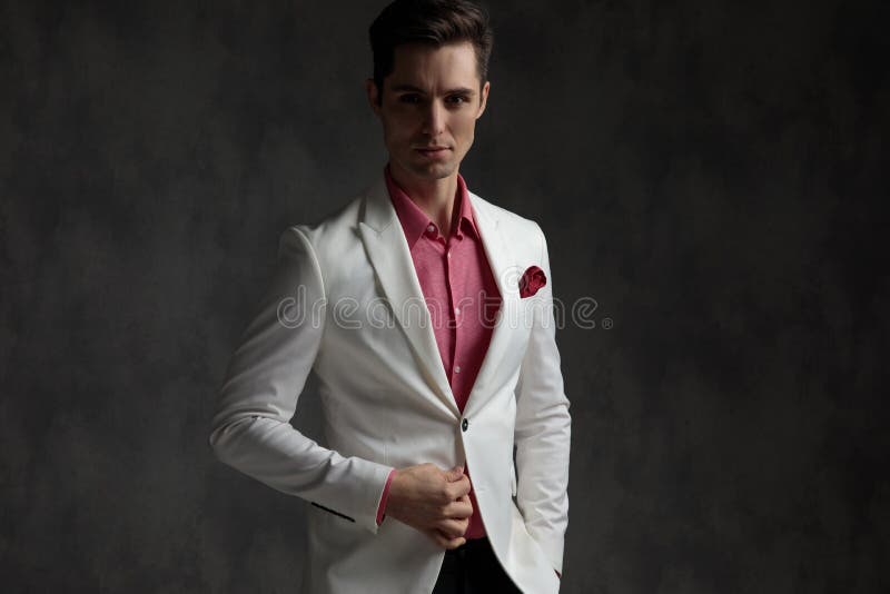Confident Elegant Man Fixing His Jacket and Looking Forward Stock Photo ...