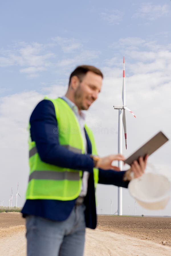Confident Engineer Overseeing Renewable Energy Project at Wind Farm ...