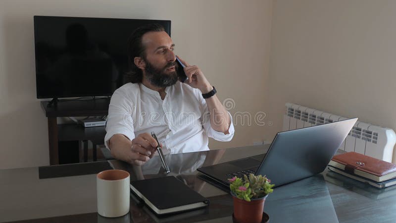 Confident Entrepreneur Discussing Business on the Phone in a Modern ...