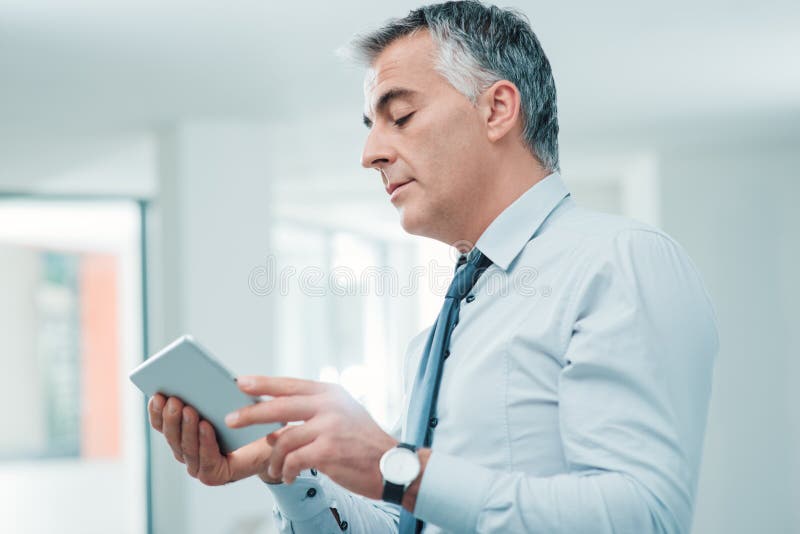Confident Executive Using a Touch Screen Tablet Stock Photo - Image of ...