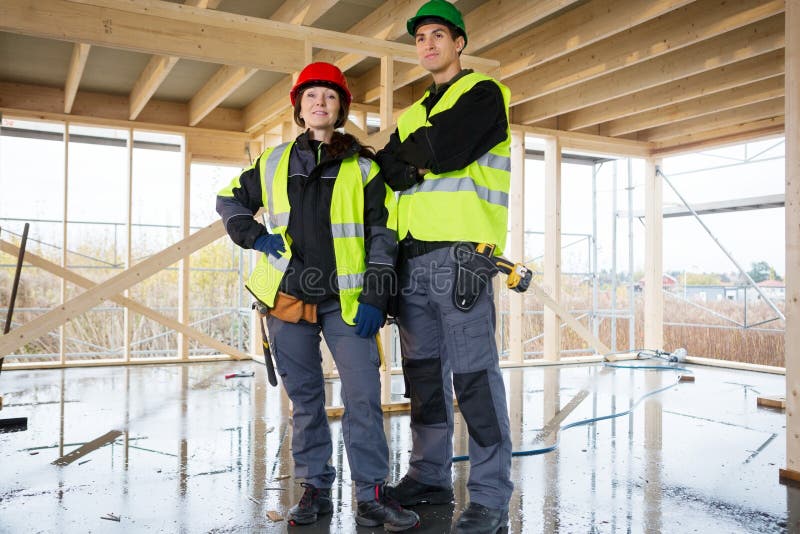 Confident Female Carpenter Standing by Colleague at Construction Stock ...