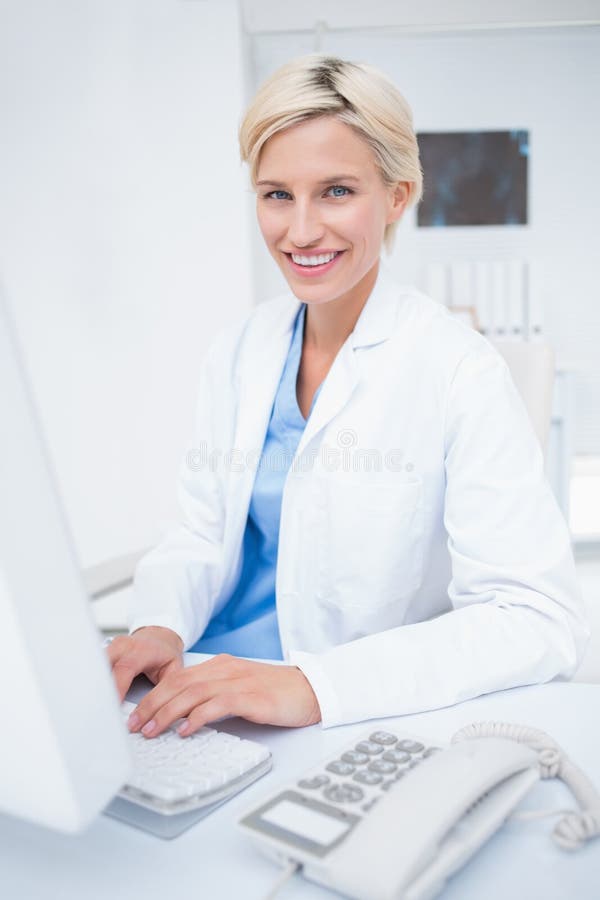 Confident Female Doctor Using Computer in Clinic Stock Image - Image of ...