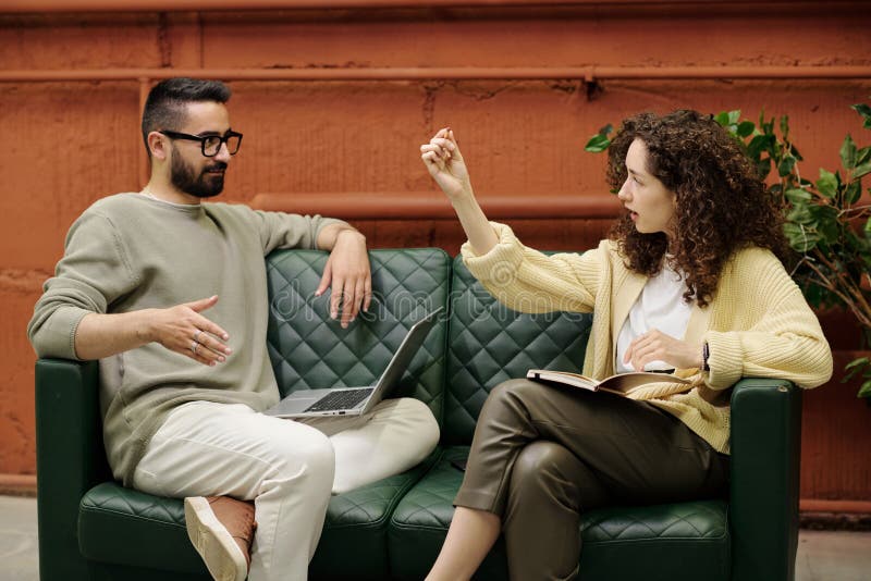Confident Female Economist with Notebook Explaining Data Analysis To ...