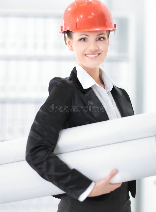Confident Female Engineer with Blueprints in the Background of the ...