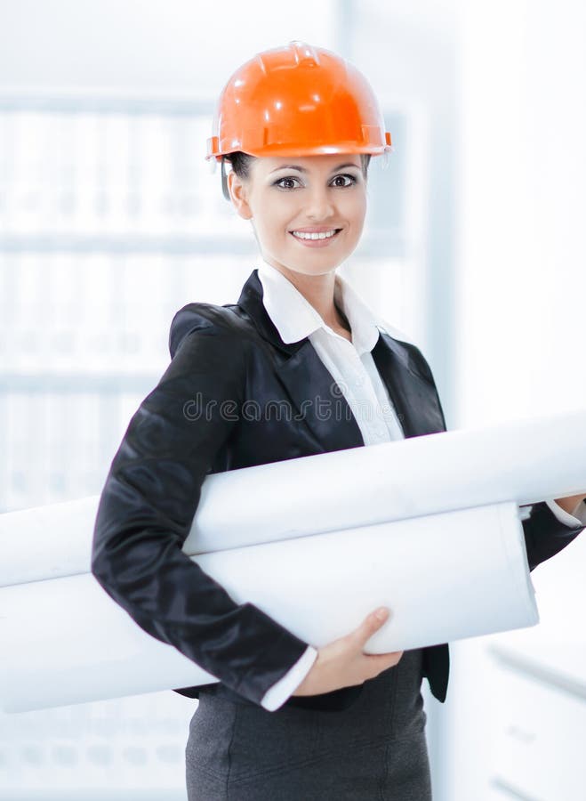 Confident Female Engineer with Blueprints in the Background of the ...