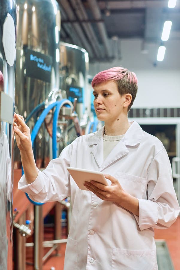 Confident Female Expert in Whitecoat Touching Control Panel of Beer ...