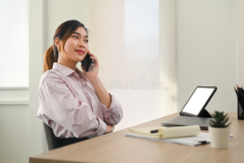 Confident Female Investment Advisor Talking on Mobile Phone with Client ...