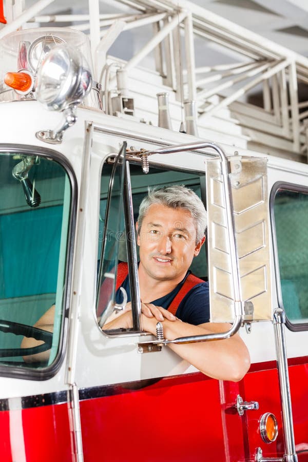 Confident Fireman Sitting in Firetruck Stock Image - Image of people ...